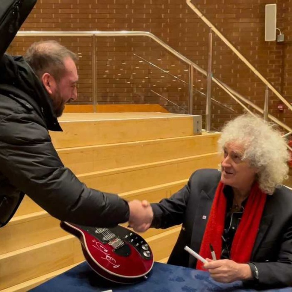 Nasconde una chitarra dentro il giubbotto e la fa autografare da Brian ...